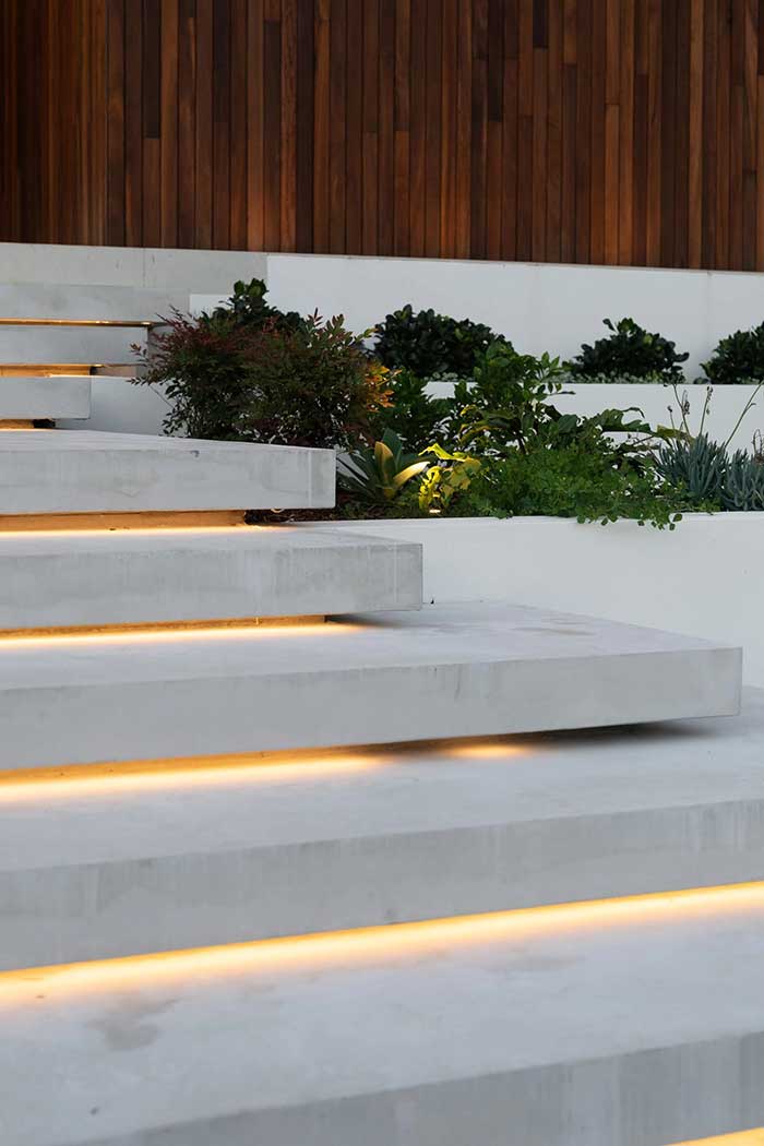 Polished concrete floating stairs create a bold architectural feature ...