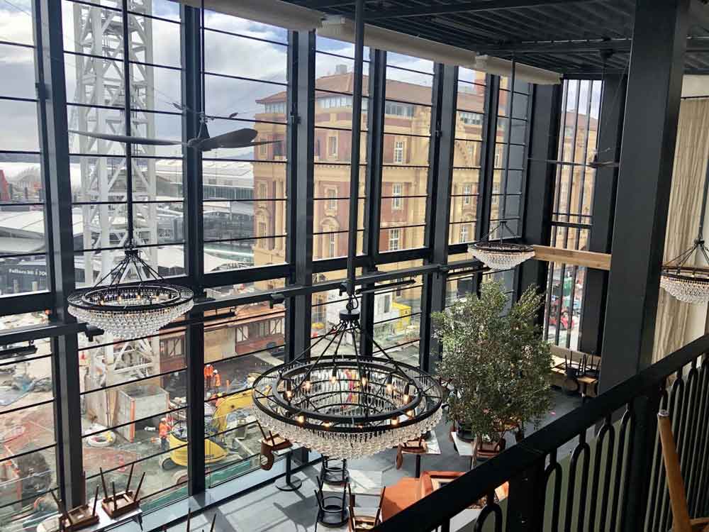 Frameless glass louvre system creates operable facade on Commercial Bay ...