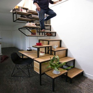 A floating labyrinth staircase that incorporates shelving and a desk ...