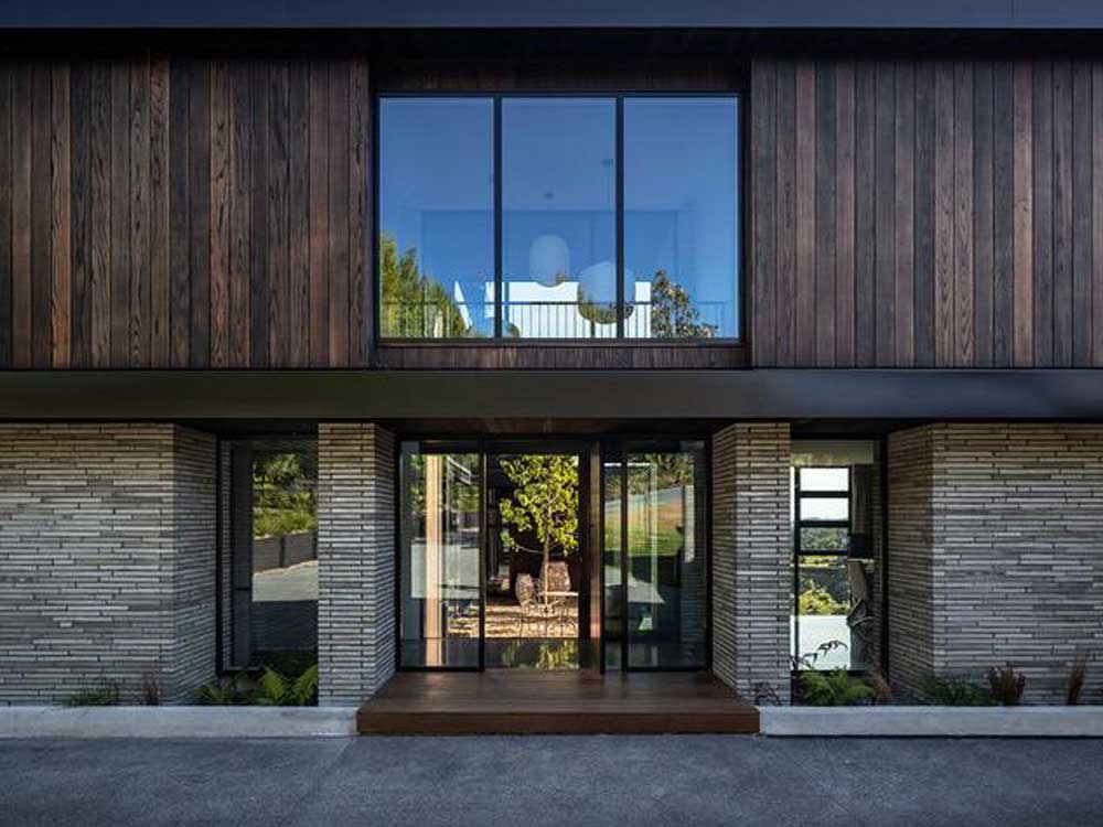 Bricks and charred timber add humanising warmth to multi-generational ...