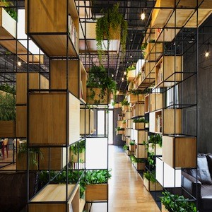 Upcycled steel bars form latticed storage dividers in Beijing café ...
